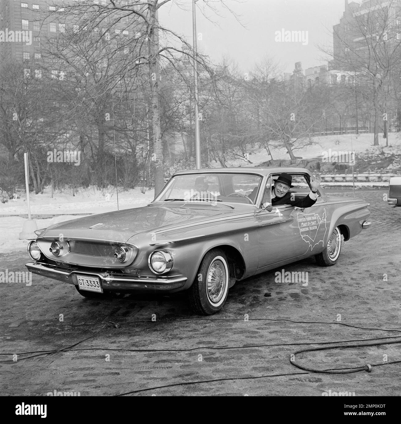 George Huebner, Chrysler Corp. research engineer, waves from the driver ...