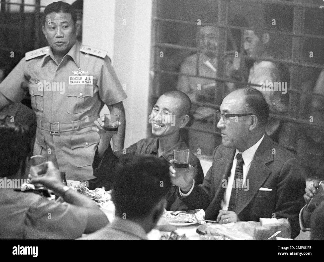 World War II Japanese straggler Hiroo Onoda, center, exchanges a toast ...