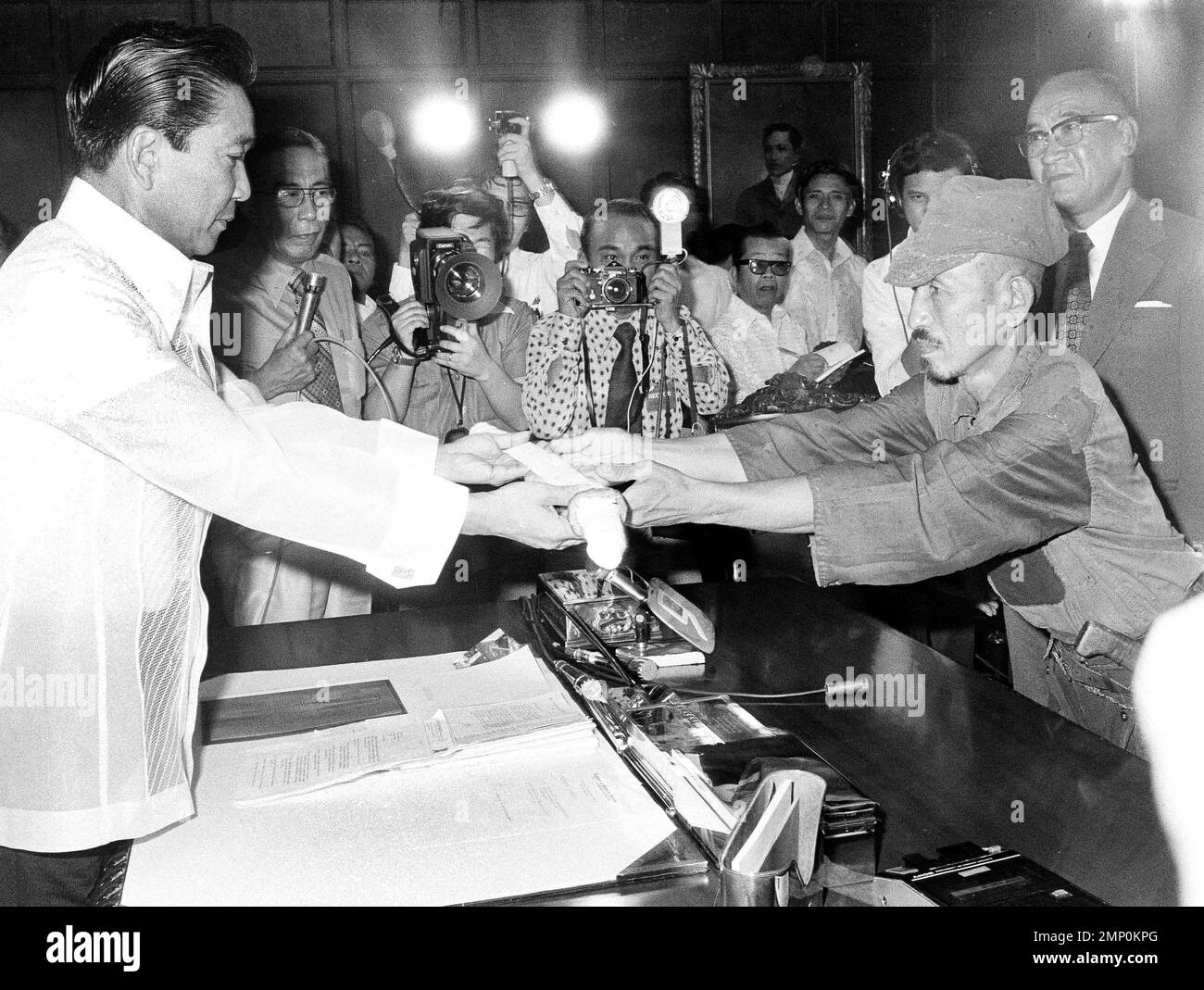 Japanese straggler Hiroo Onoda, right, surrenders his Samurai sword to ...