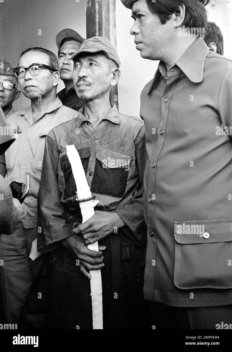 Japanese World War II straggler Lt. Hiroo Onoda presents his Samurai sword, swathed in gauze, in ...