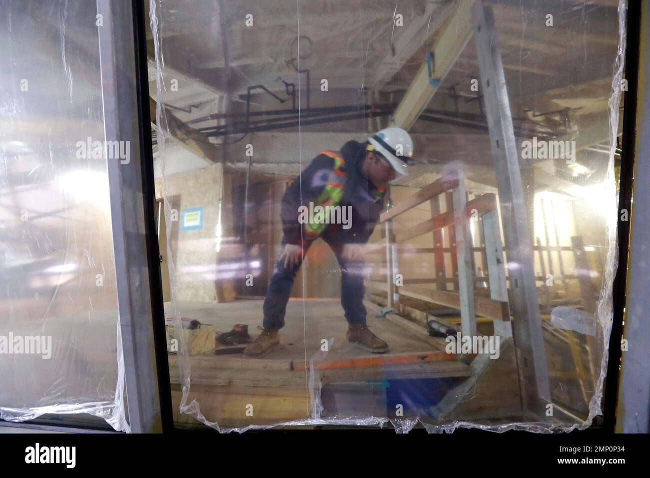 A worker looks over a window on the observation deck on the Space ...