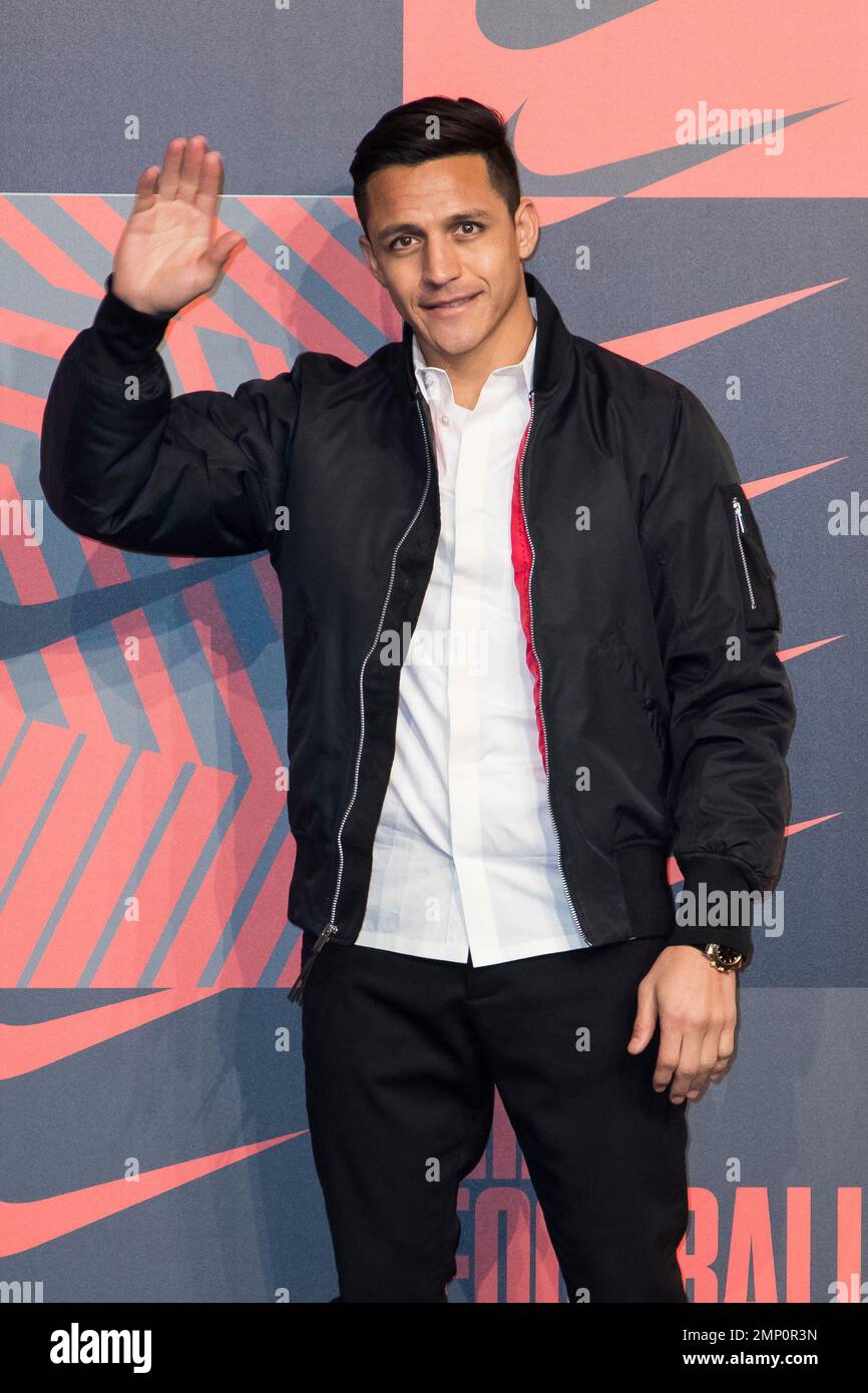 Soccer player Alexis Sanchez poses for photographers upon arrival at ...