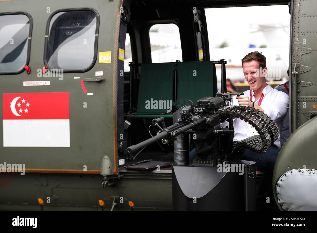 A visitor poses with the cabin-door machine gun of a Republic of ...
