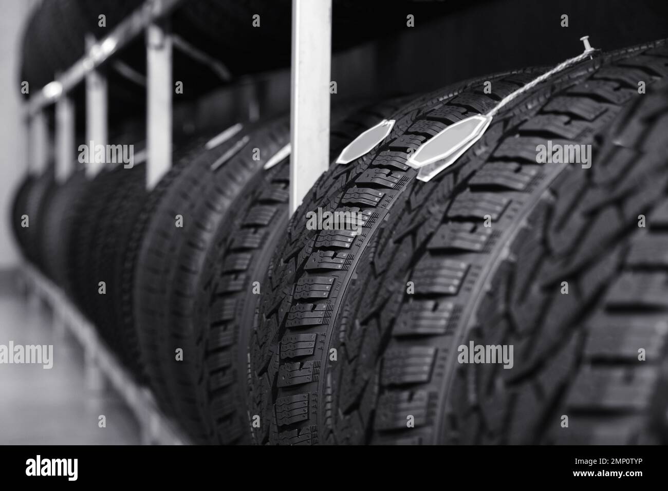 Car tires on rack in auto store, closeup Stock Photo - Alamy