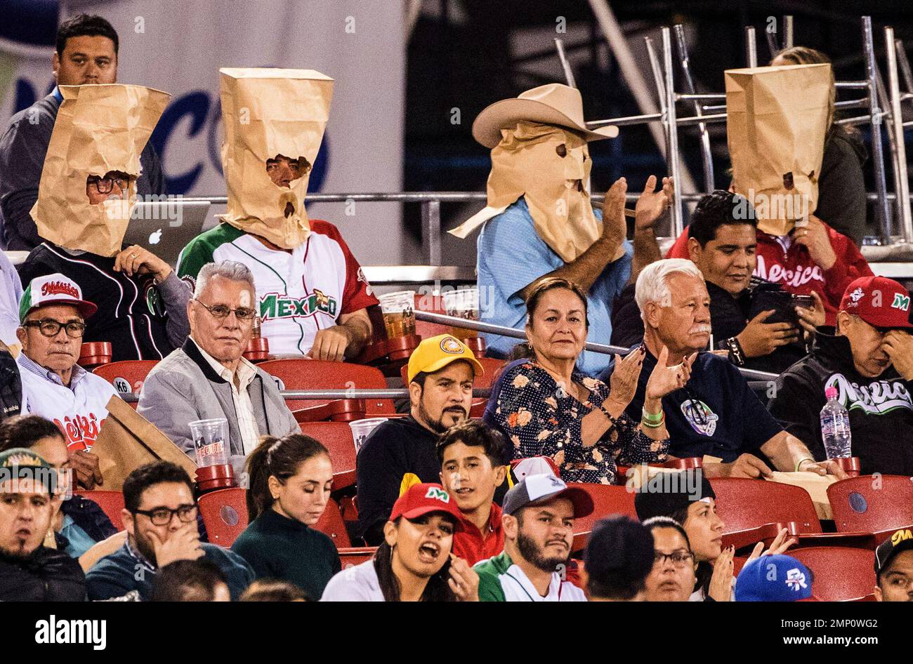 Mexico baseball fans wear paper bags over their heads during a ...