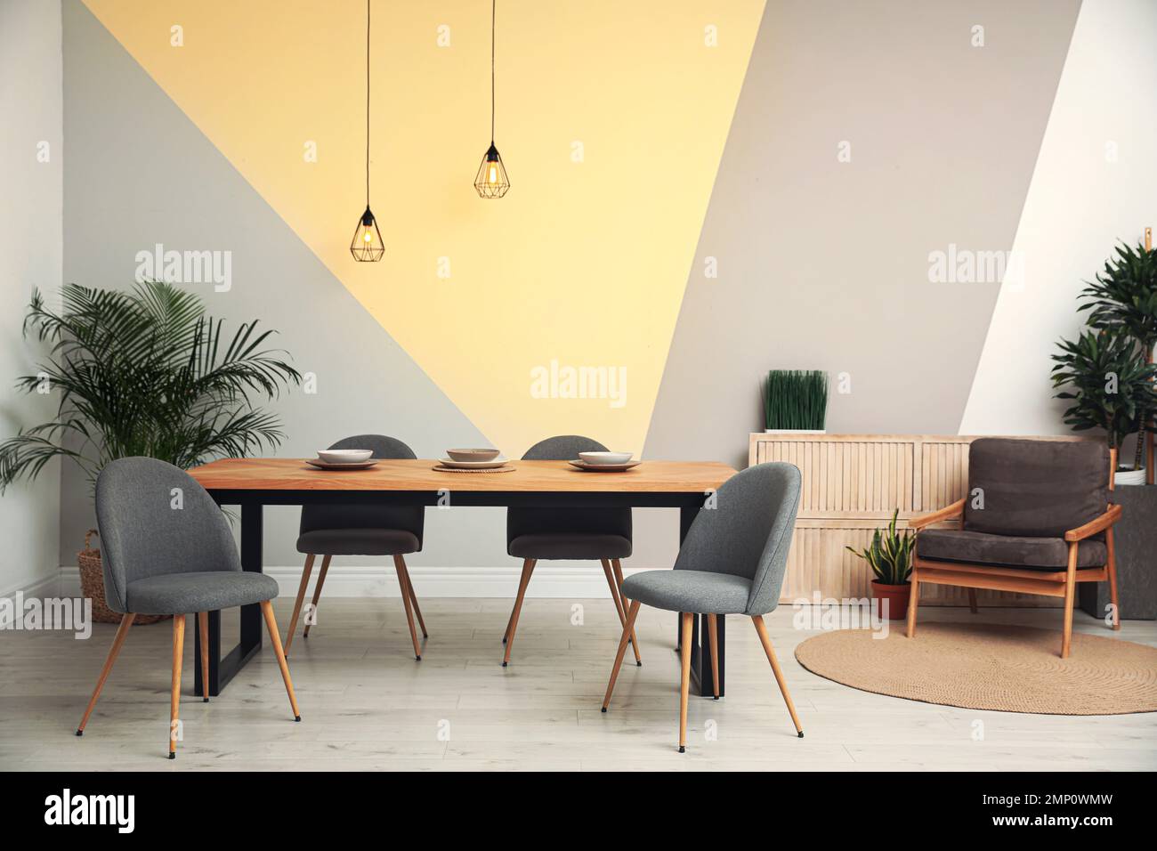 Modern wooden dining table in room interior Stock Photo - Alamy