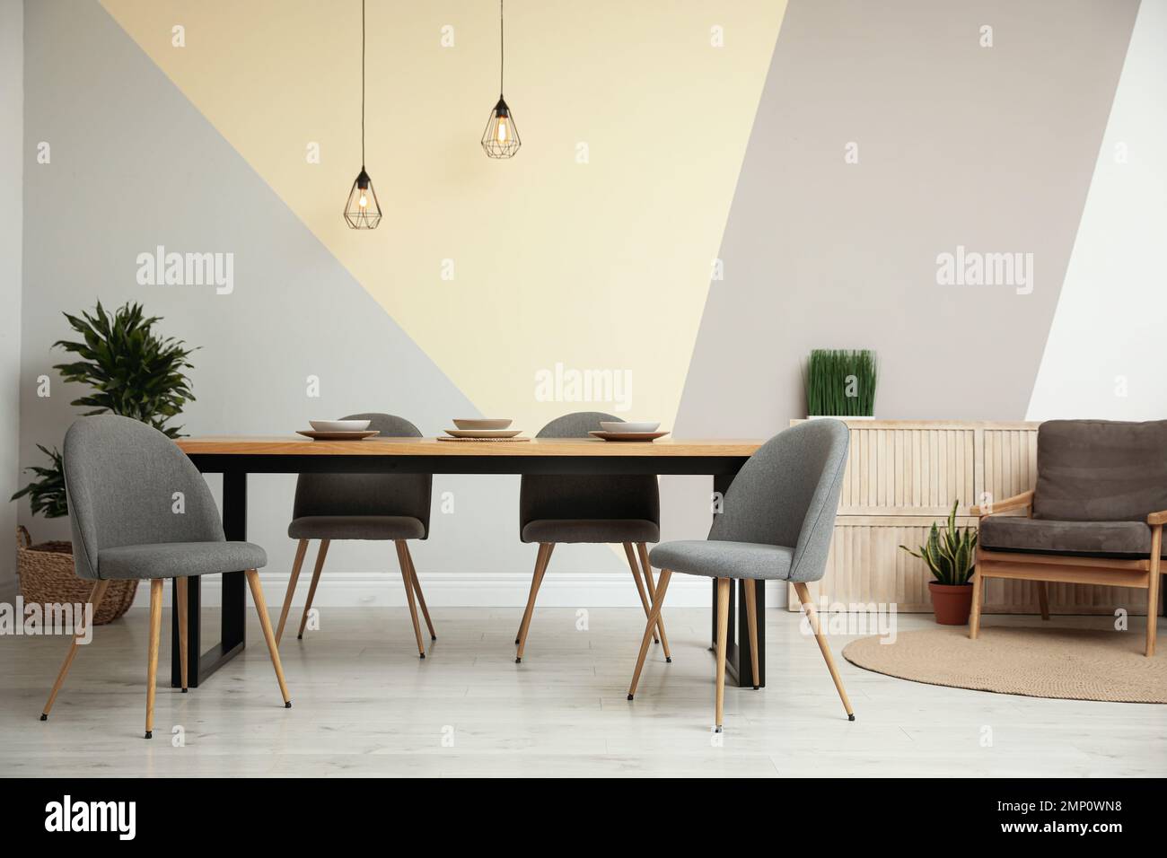 Modern wooden dining table in room interior Stock Photo - Alamy