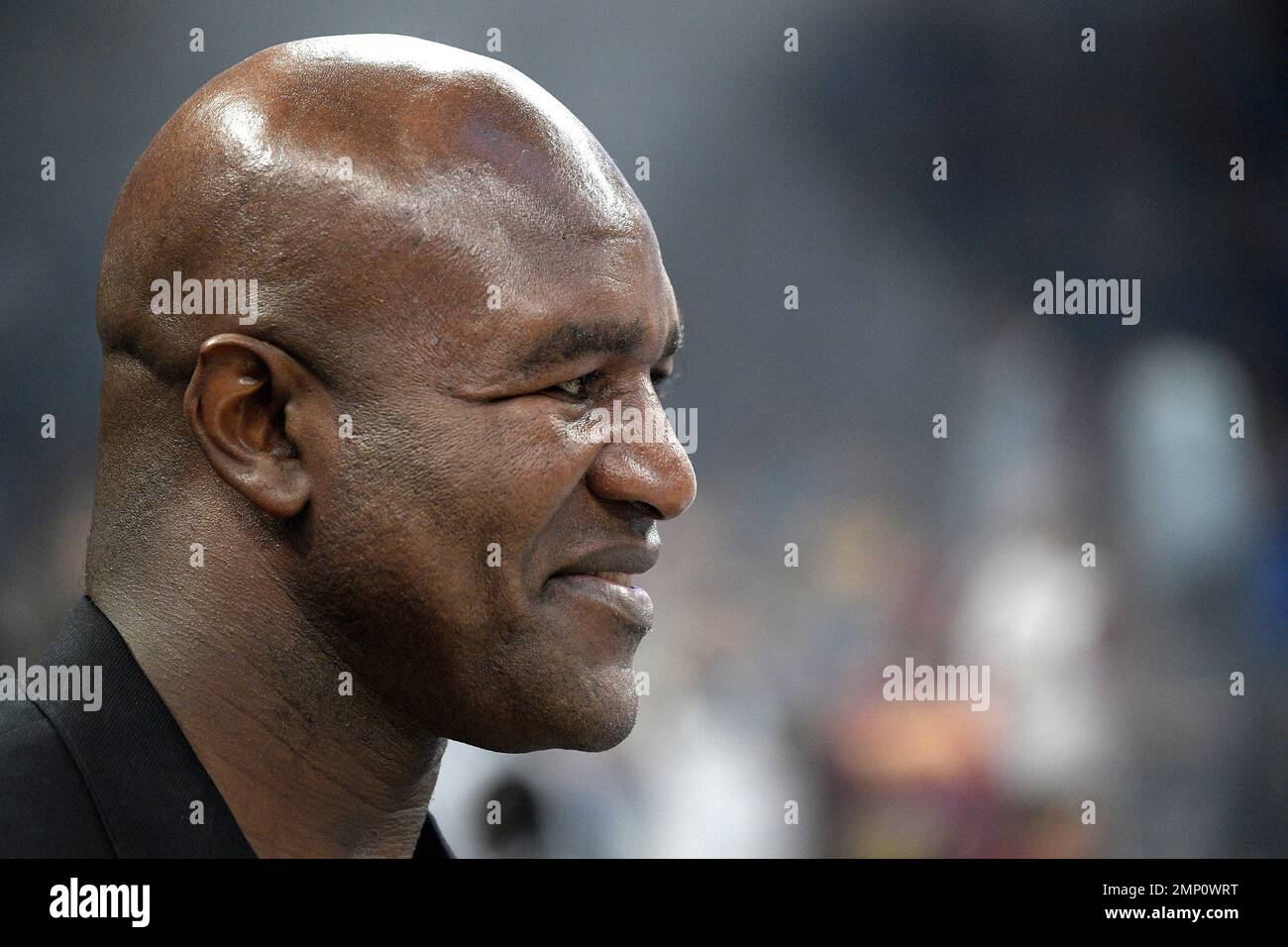 Former professional boxer Evander Holyfield stands on the court during ...