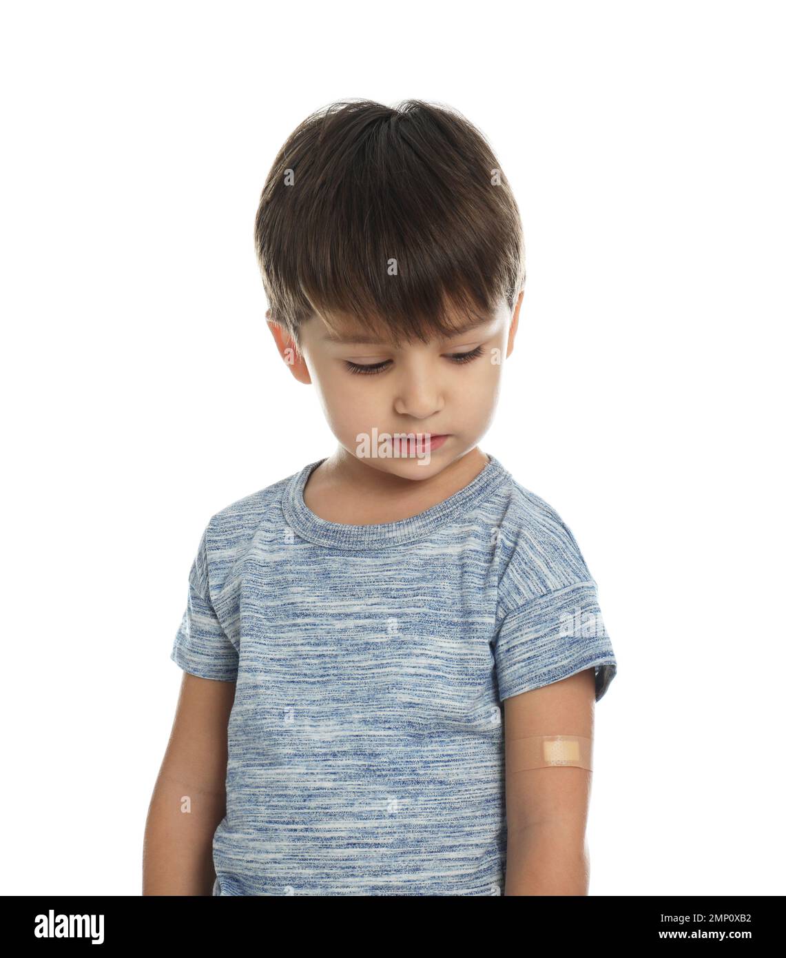 Little boy with sticking plaster on arm against white background Stock ...