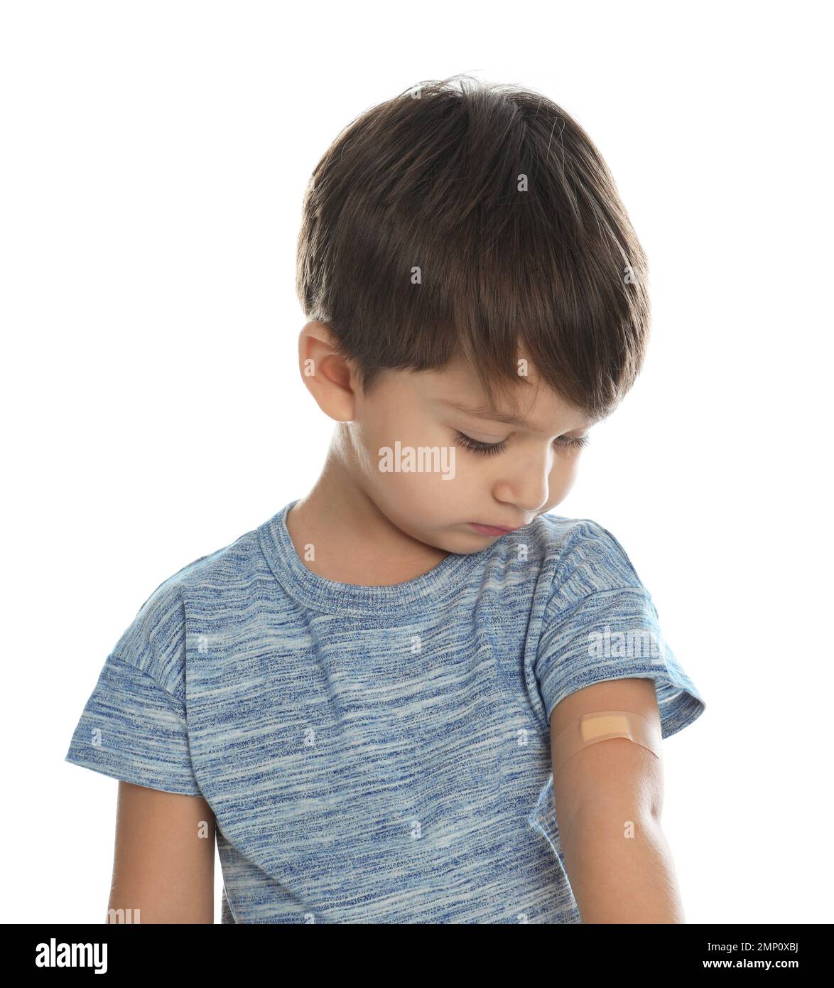 Little boy with sticking plaster on arm against white background Stock ...