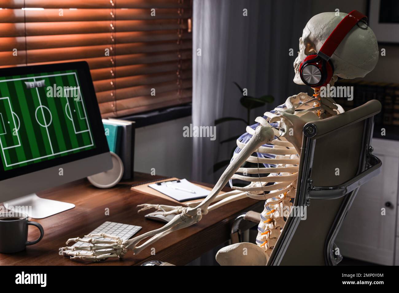 Human skeleton with headphones playing game indoors Stock Photo - Alamy