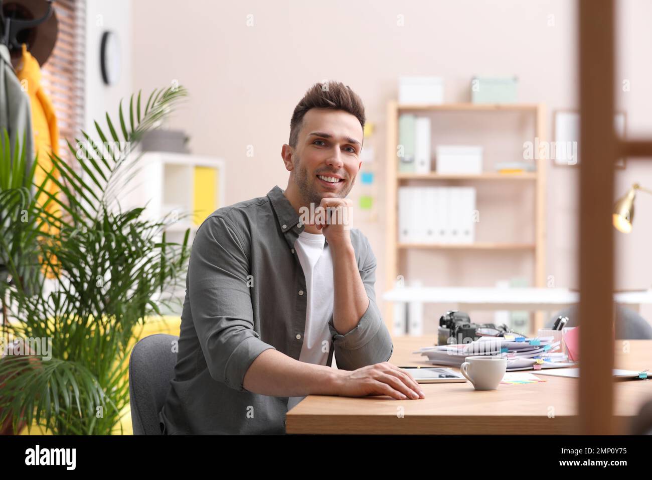Young journalist at workplace in light office Stock Photo - Alamy