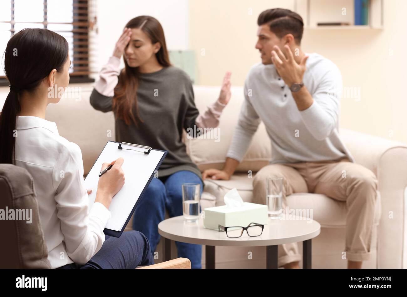 Professional psychologist working with couple in office Stock Photo - Alamy