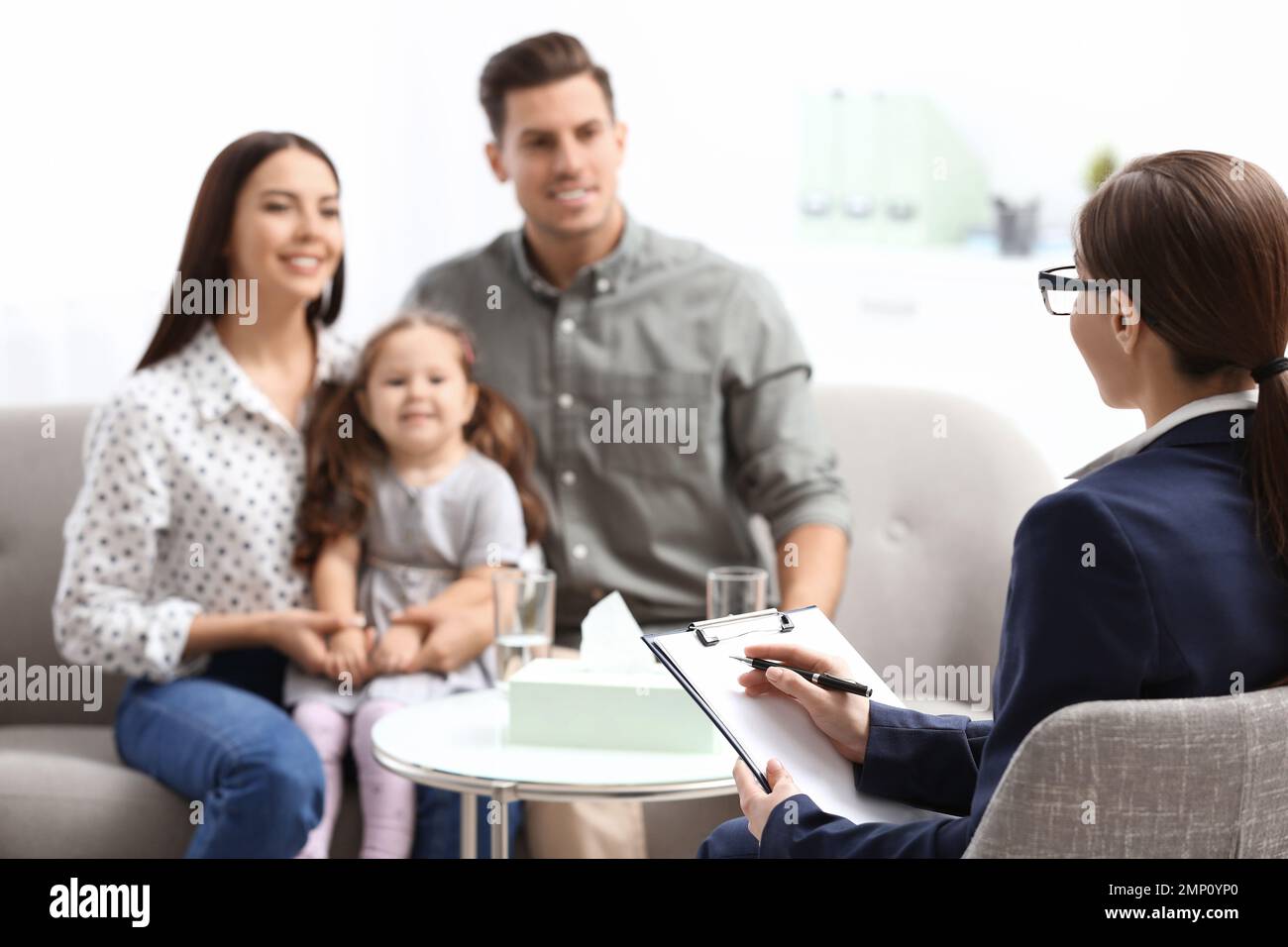Professional psychologist working with family in office Stock Photo - Alamy