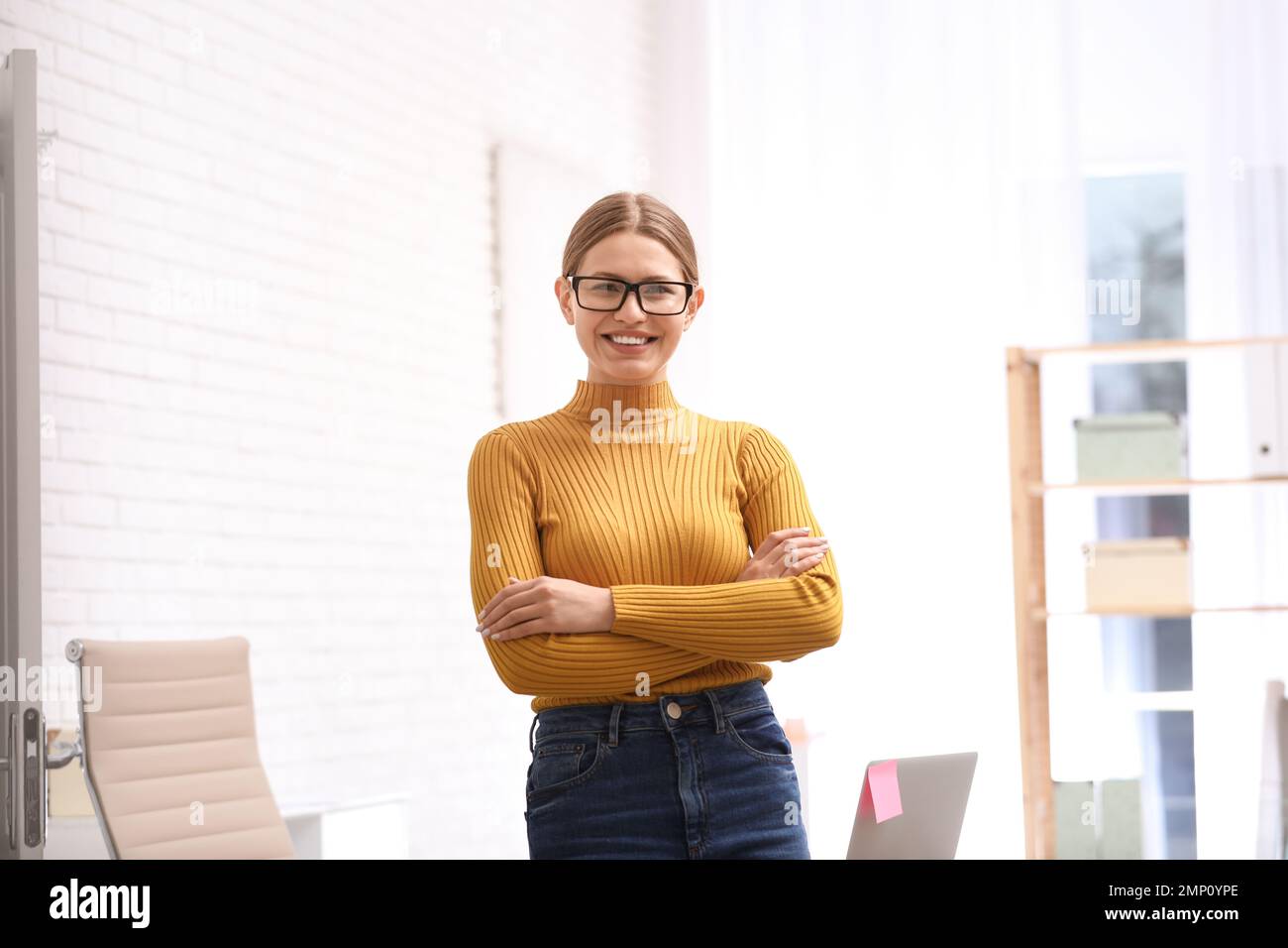 Young journalist at workplace in light office Stock Photo - Alamy