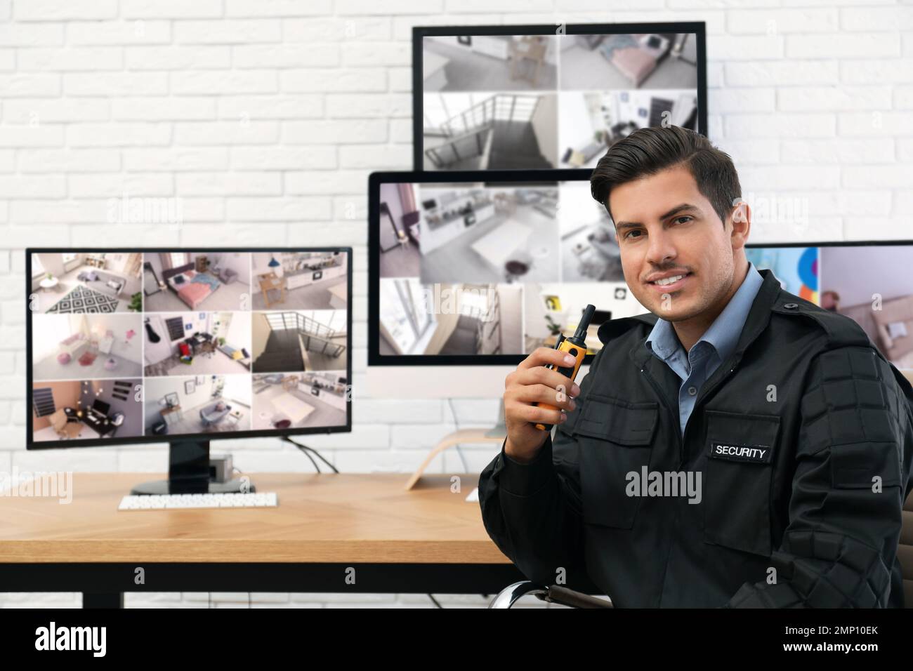 Male security guard with portable transmitter at workplace Stock Photo ...