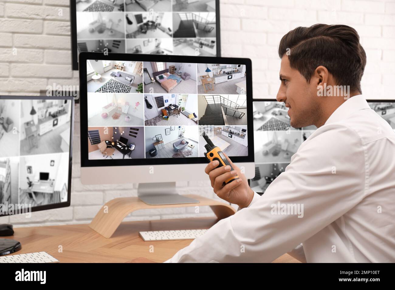 Male security guard with portable transmitter at workplace Stock Photo ...