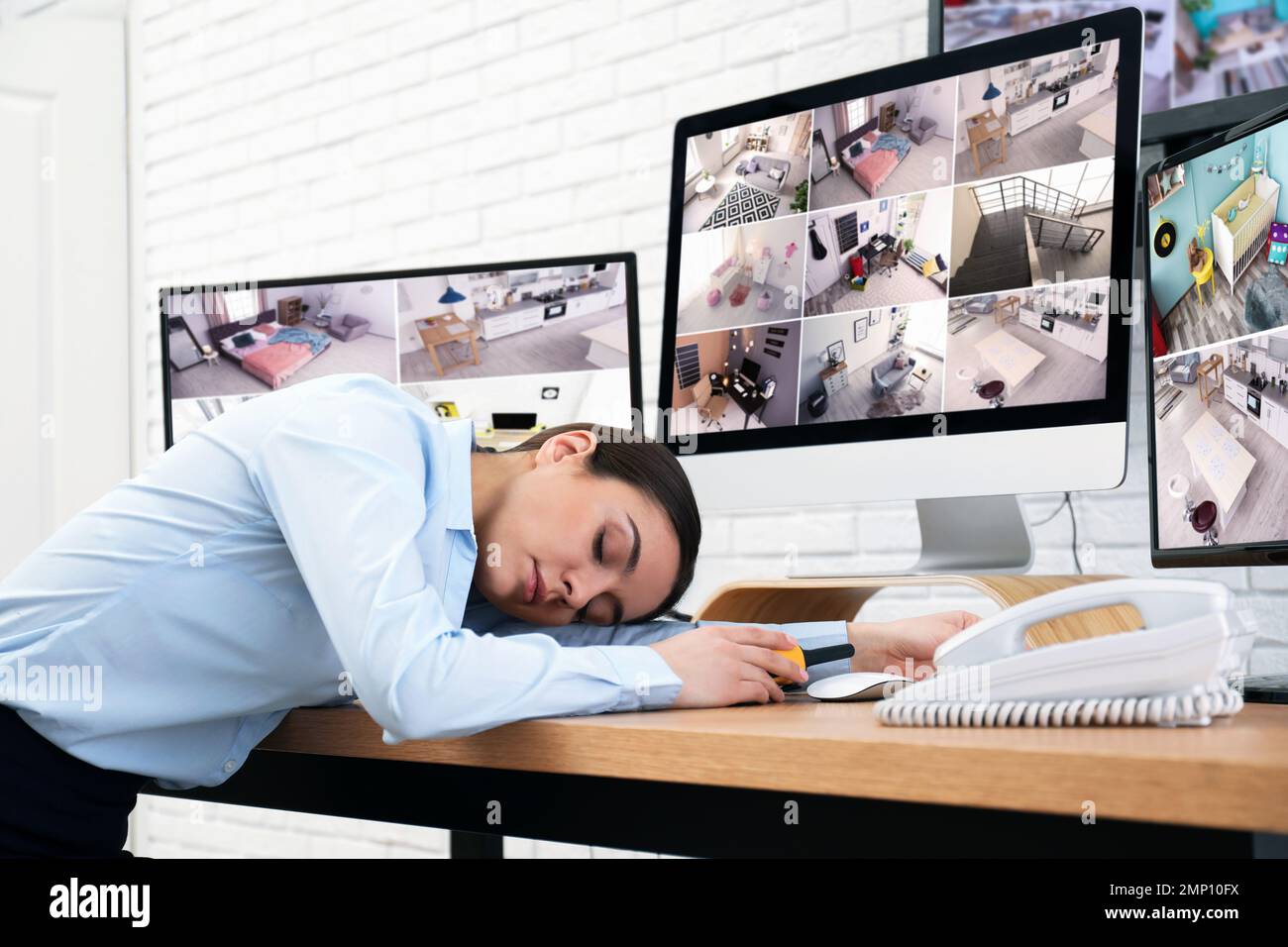 Female security guard sleeping near monitors at workplace Stock Photo ...