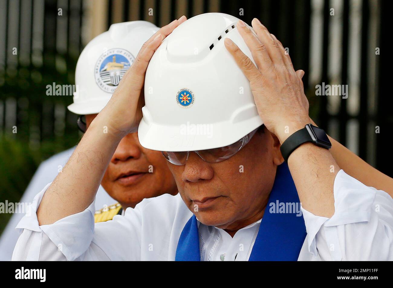 Philippine President Rodrigo Duterte dons a hard hat and a protective ...