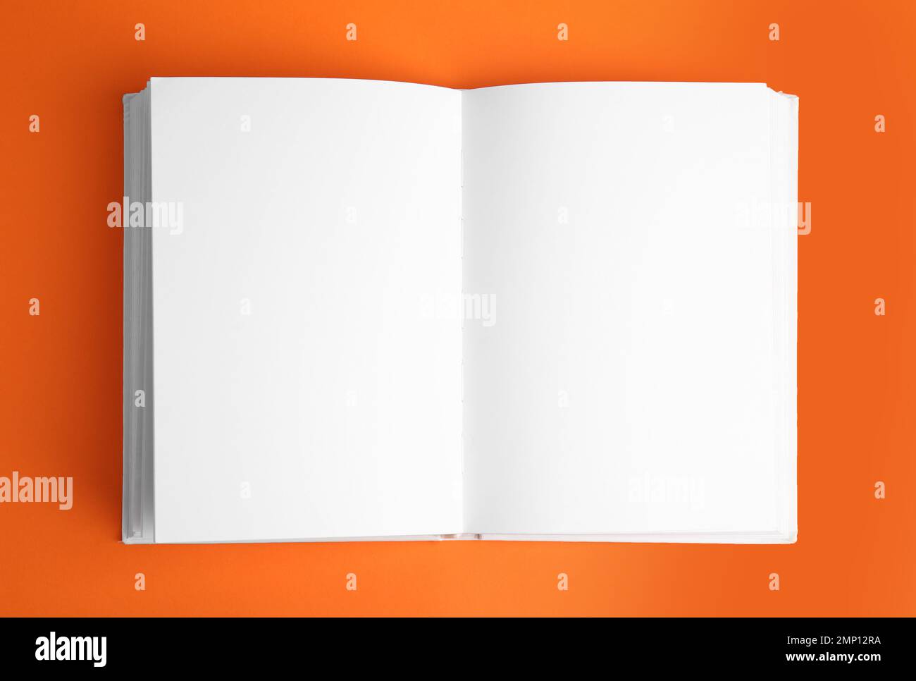 Open book with blank pages on orange background Stock Photo - Alamy