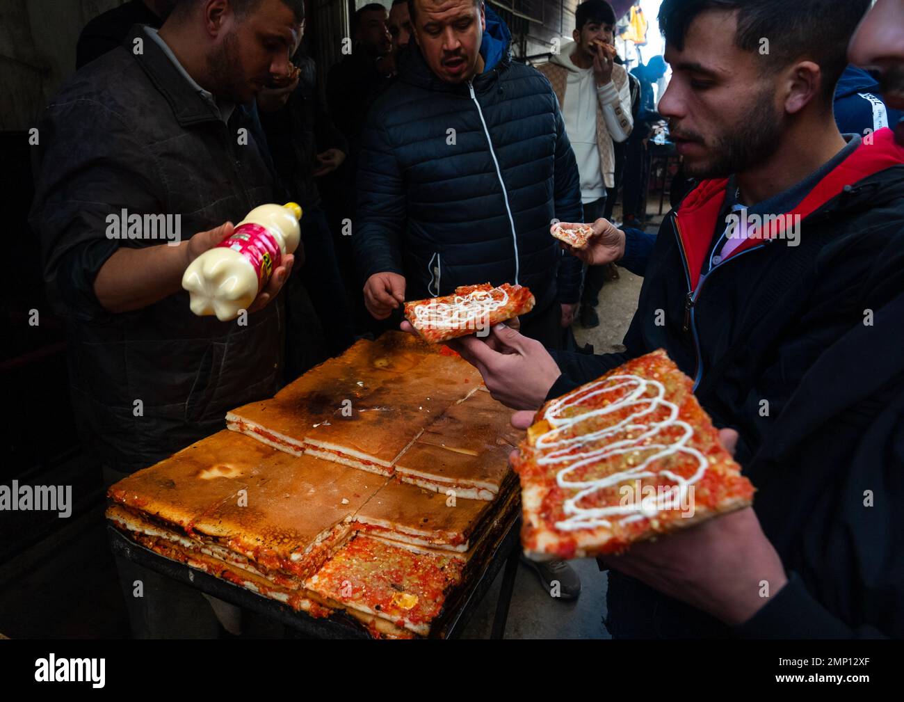 Algerian people buying pizzas in Souk El Ghezel, North Africa ...