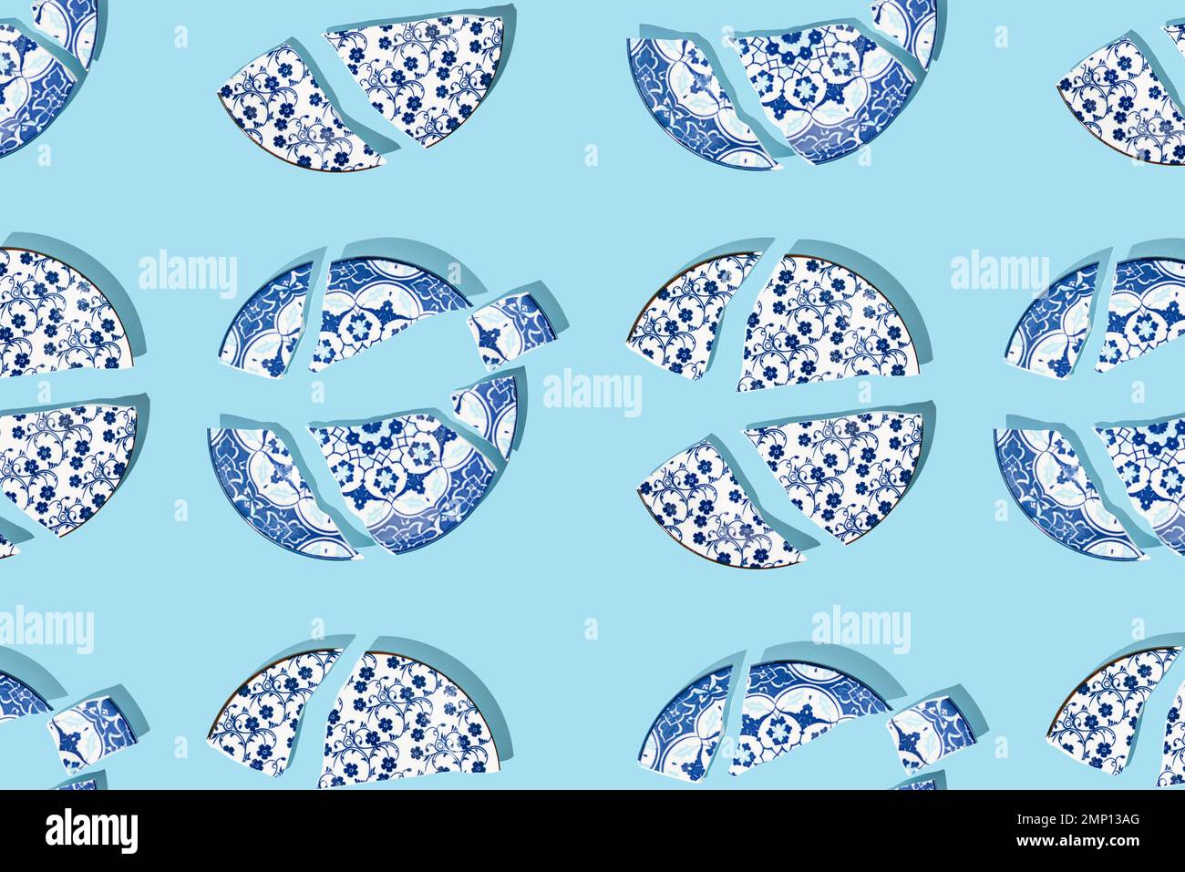 Pattern with broken china porcelain plates on blue background. Minimal ...