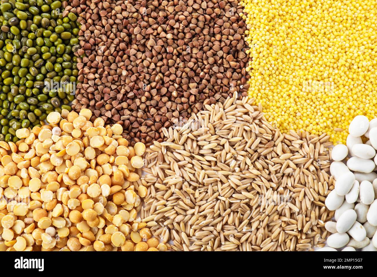 Different grains and cereals as background, top view Stock Photo - Alamy