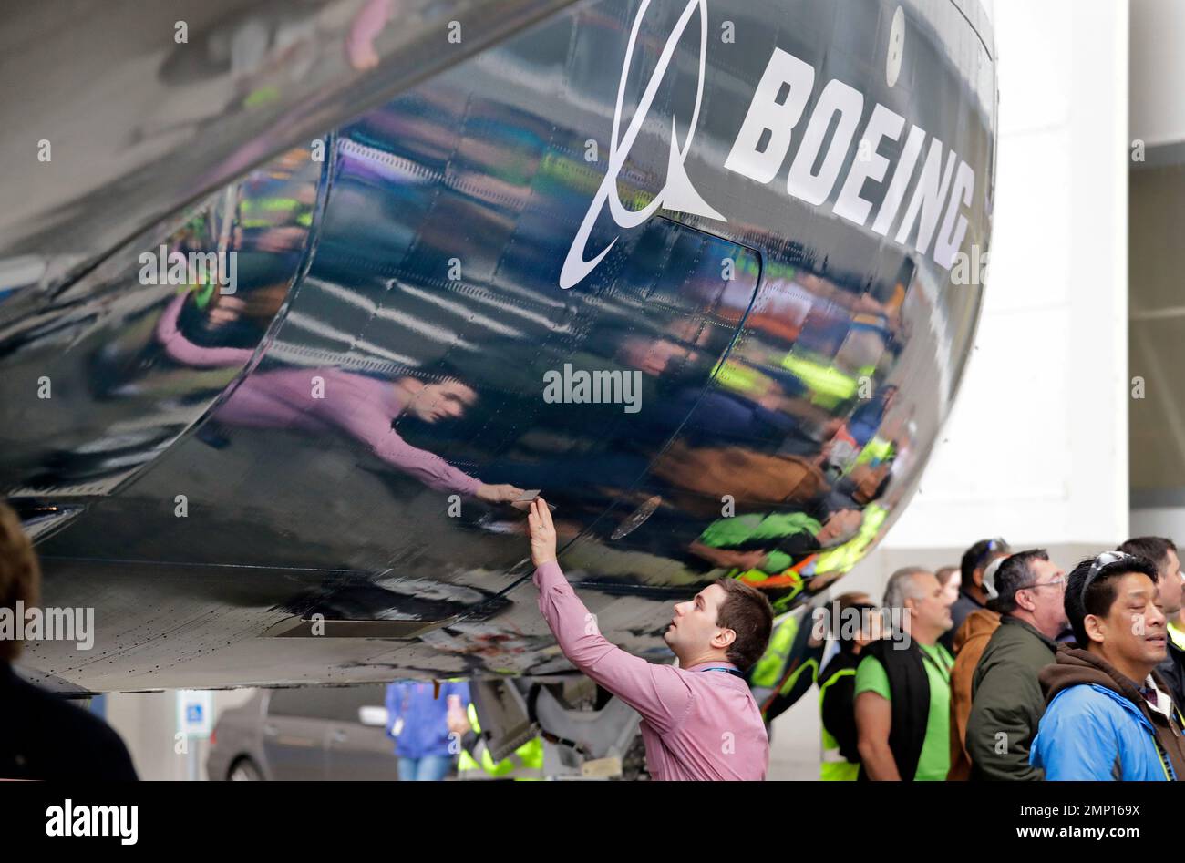 Boeing worker Paul Covaci reaches out to touch a Boeing 737 MAX 7, the ...