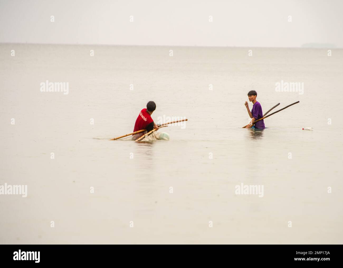 22 January 2023- Chumphon Thailand fishermen fish with nets in shallow ...
