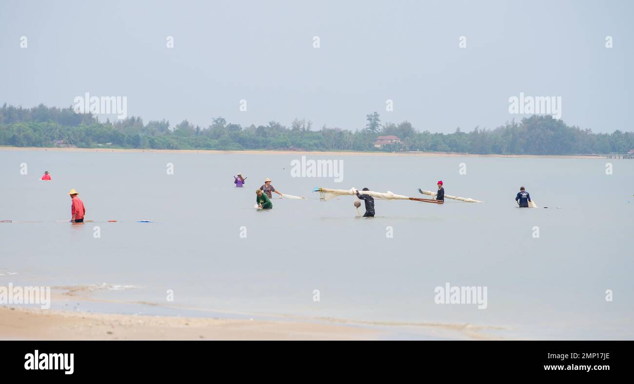22 January 2023- Chumphon Thailand fishermen fish with nets in shallow ...