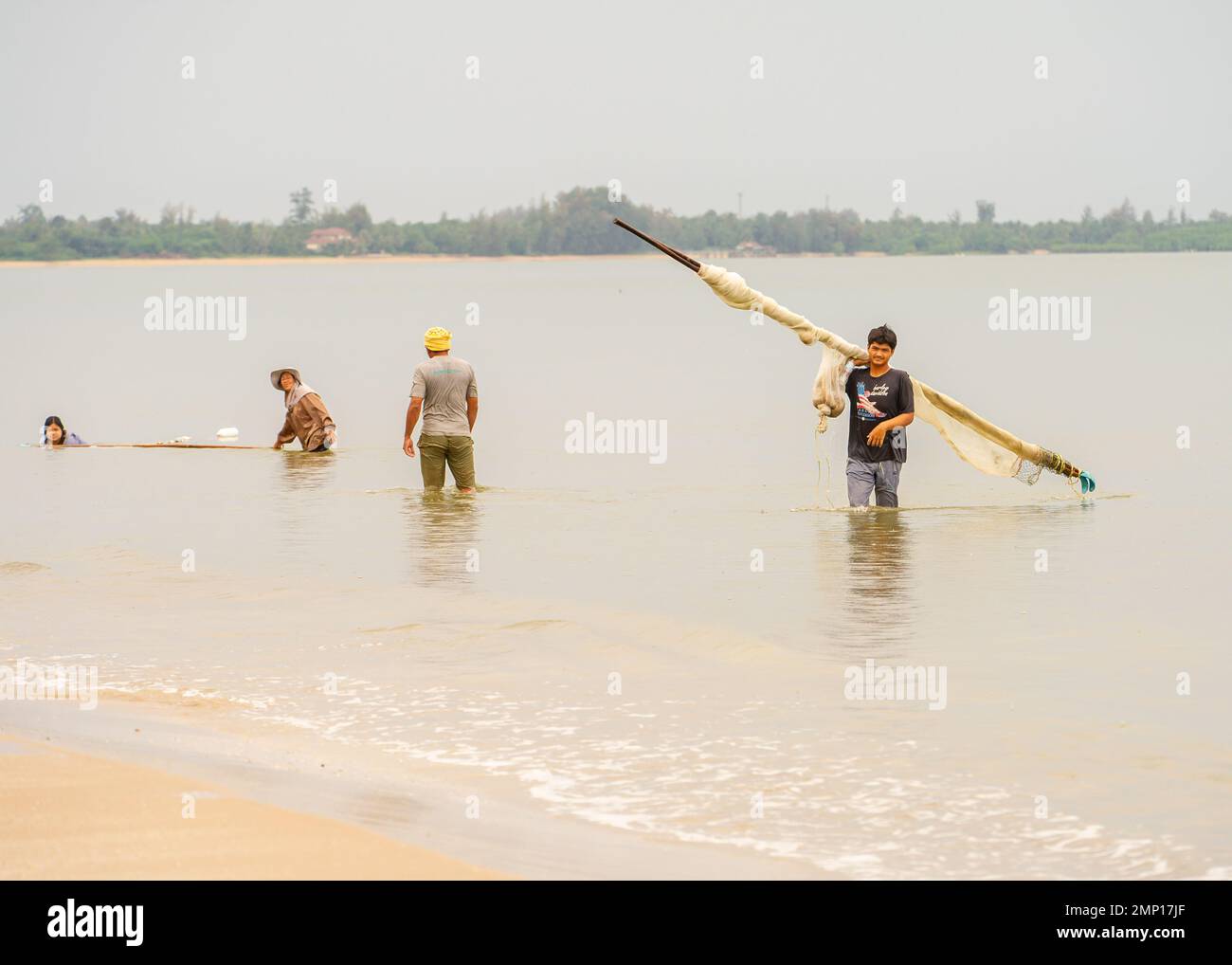 22 January 2023- Chumphon Thailand fishermen fish with nets in shallow ...