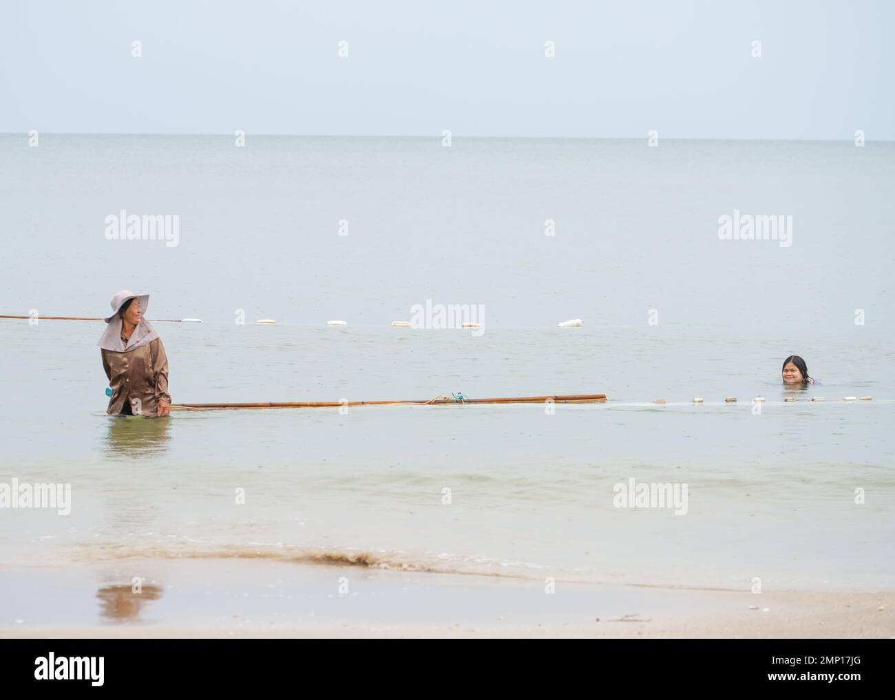 22 January 2023- Chumphon Thailand fishermen fish with nets in shallow ...