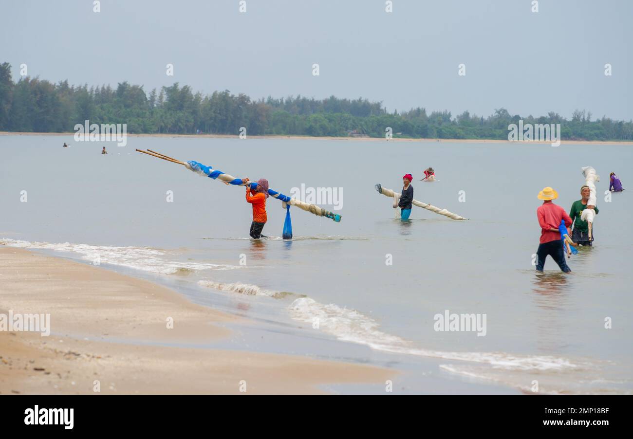 22 January 2023- Chumphon Thailand fishermen fish with nets in shallow ...