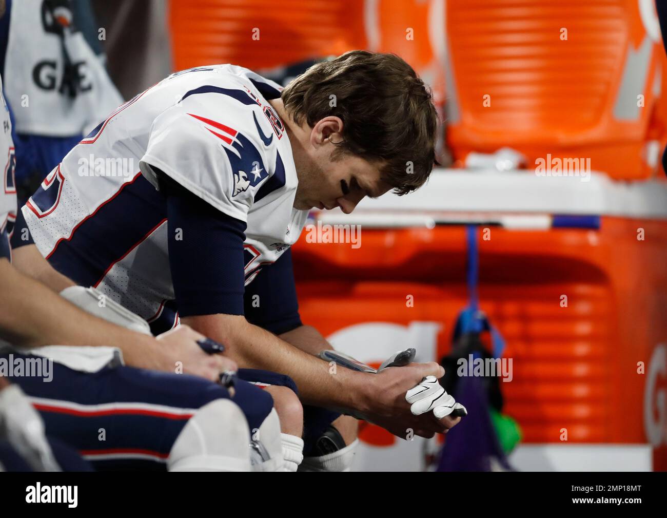 New England Patriots' Tom Brady sits on the bench after losing a fumble ...