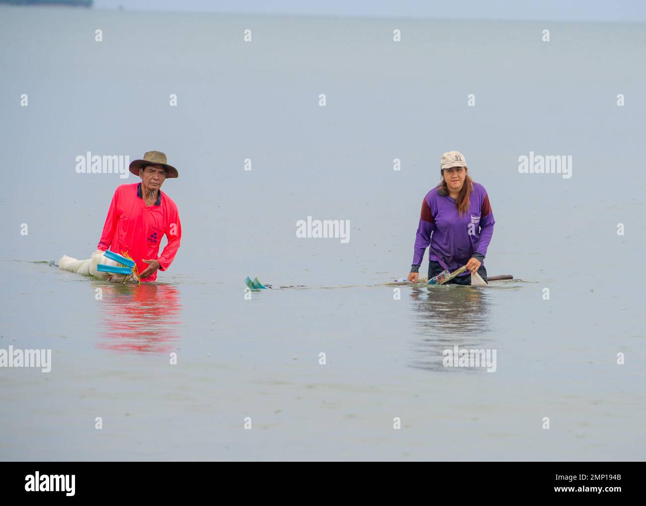 22 January 2023- Chumphon Thailand fishermen fish with nets in shallow ...