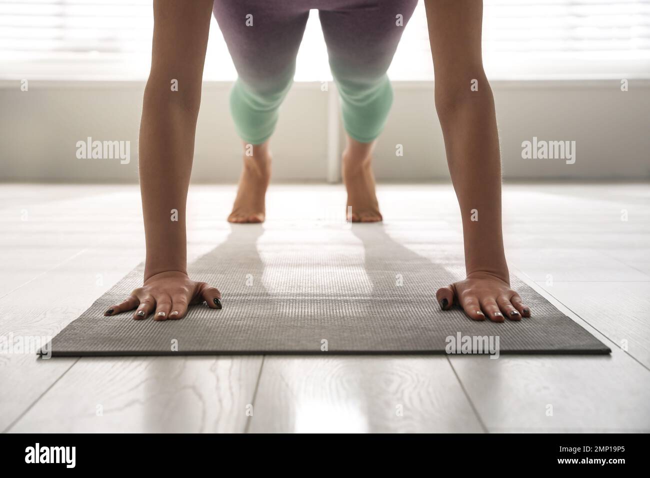 Woman practicing plank asana in yoga studio, closeup. Phalankasana pose ...