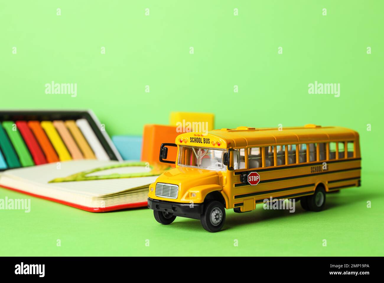 School bus model and stationery on green background. Transport for ...