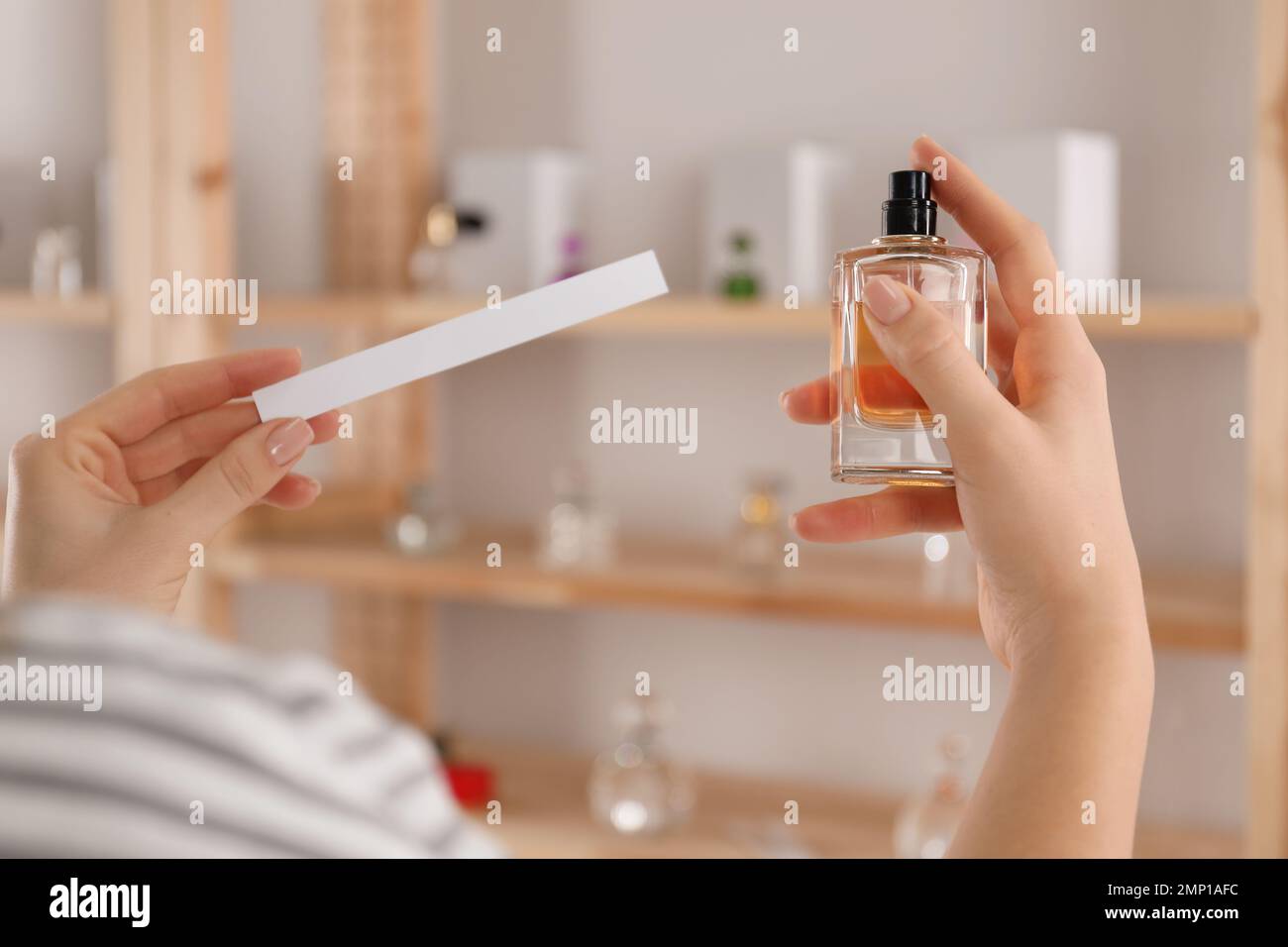 Woman spray perfume tester hi-res stock photography and images - Alamy