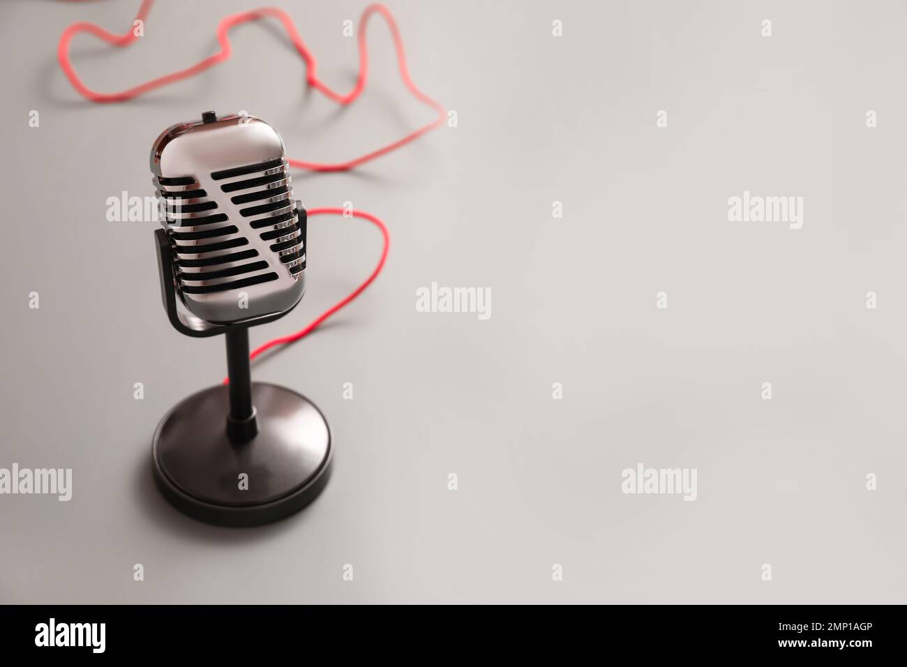 Vintage microphone on light grey table, space for text Stock Photo - Alamy