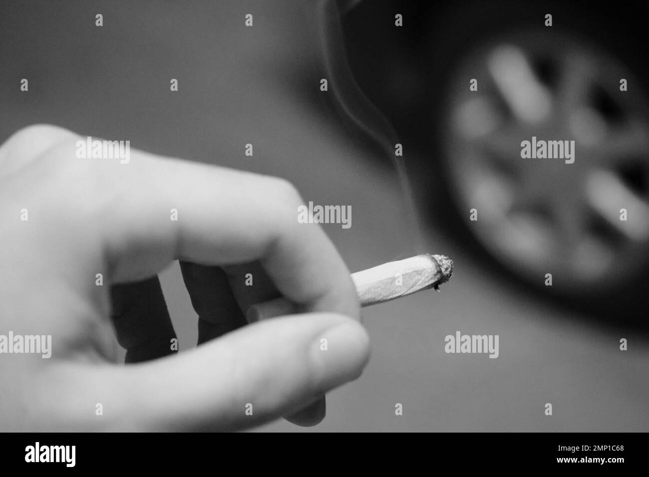 Black and White picture of a person smoking a cigarette Stock Photo - Alamy