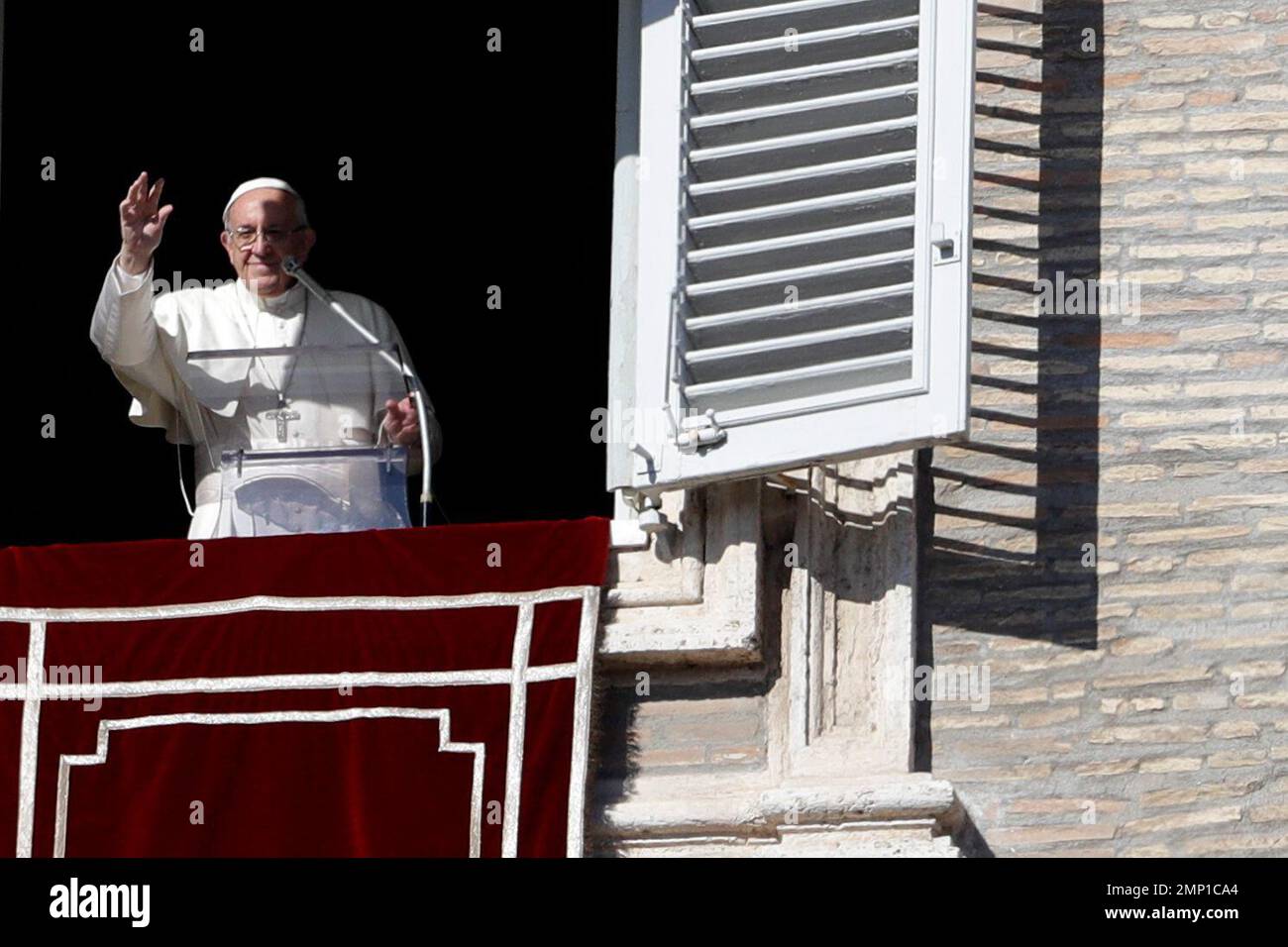 Pope Francis waves to faithful from his studio's window overlooking St ...
