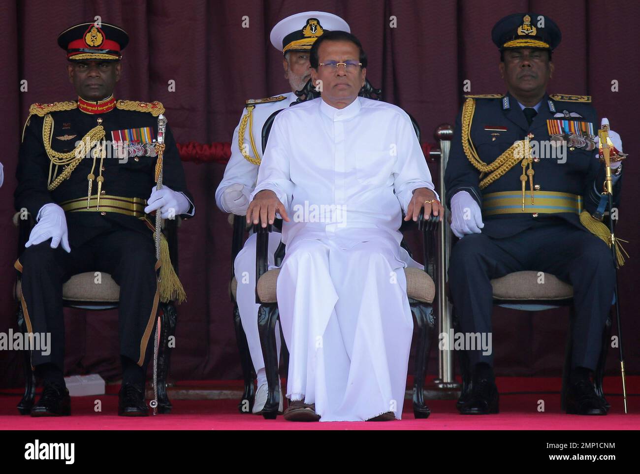 Sri Lankan President Maithripala Sirisena, center, along with security ...