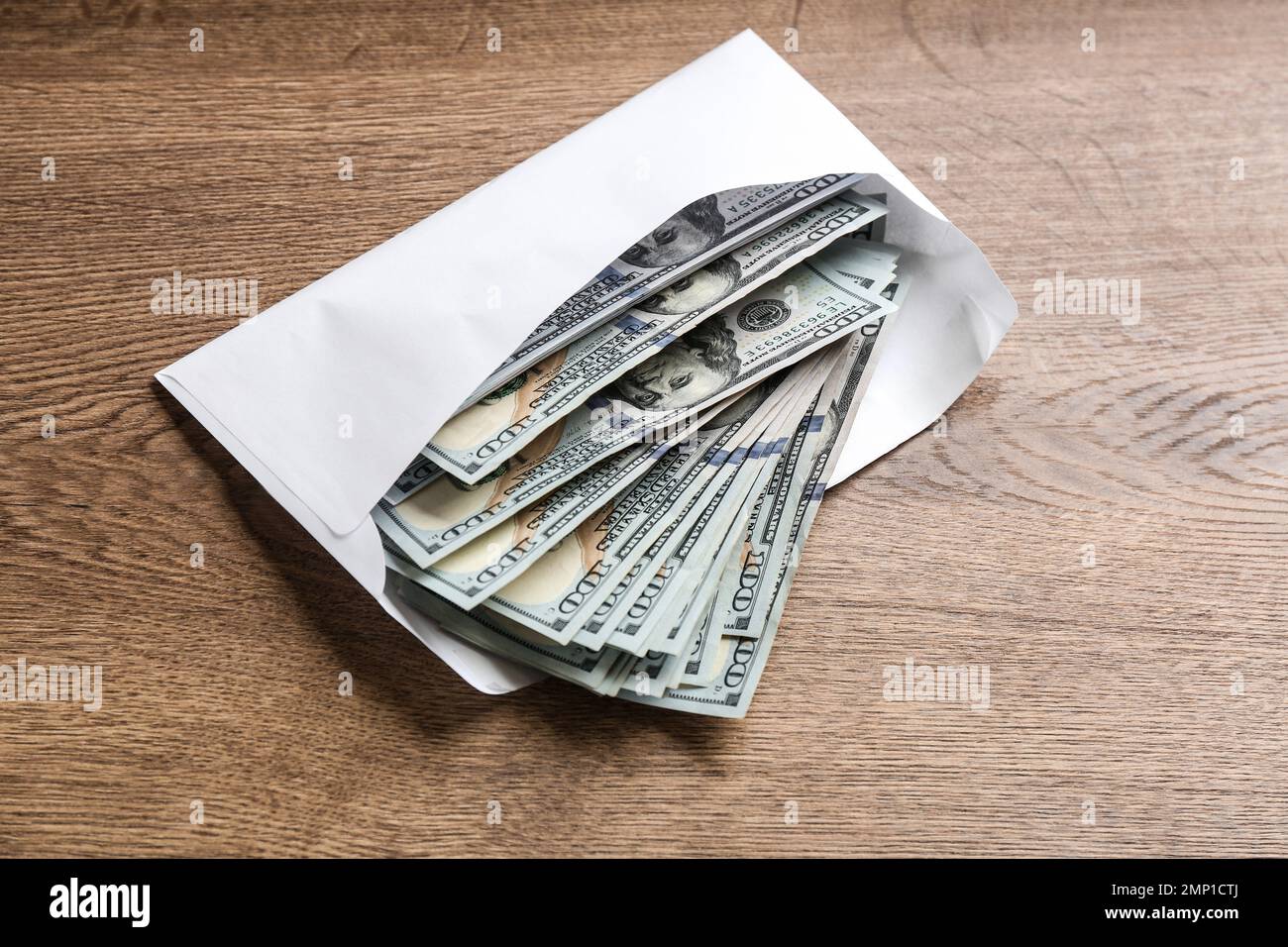 Envelope with dollar bills on wooden table. Bribe concept Stock Photo ...