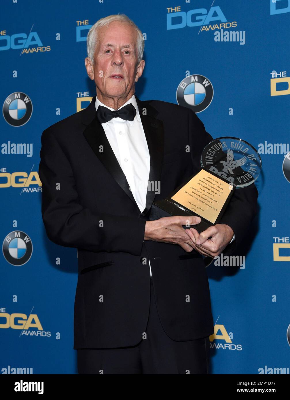 Michael Apted poses in the press room with the honorary life member ...