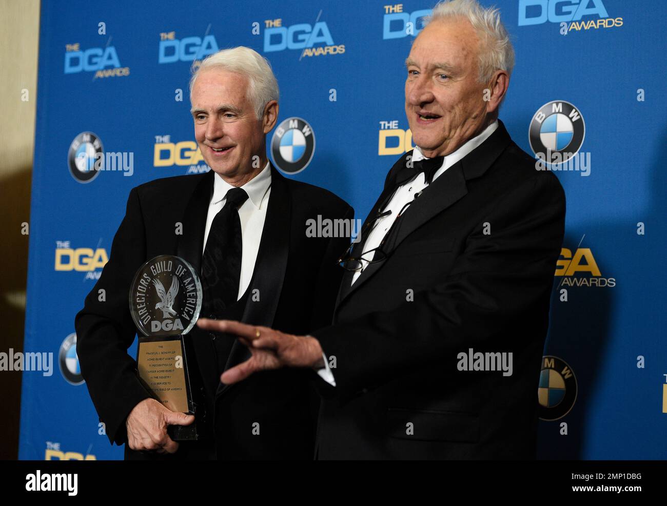 Don Mischer, right, poses in the press room with Jim Tanker, winner of ...