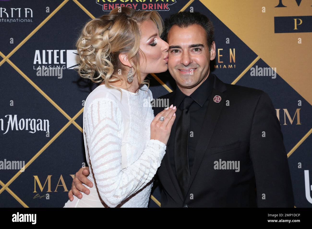 Actress Anya Benton kisses Robert Golden at the Maxim Super Bowl Party ...