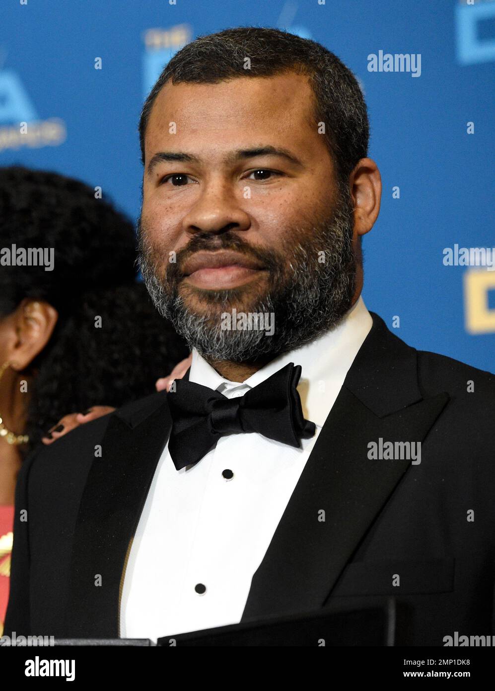 Jordan Peele poses in the press room with a medallion honoring his ...