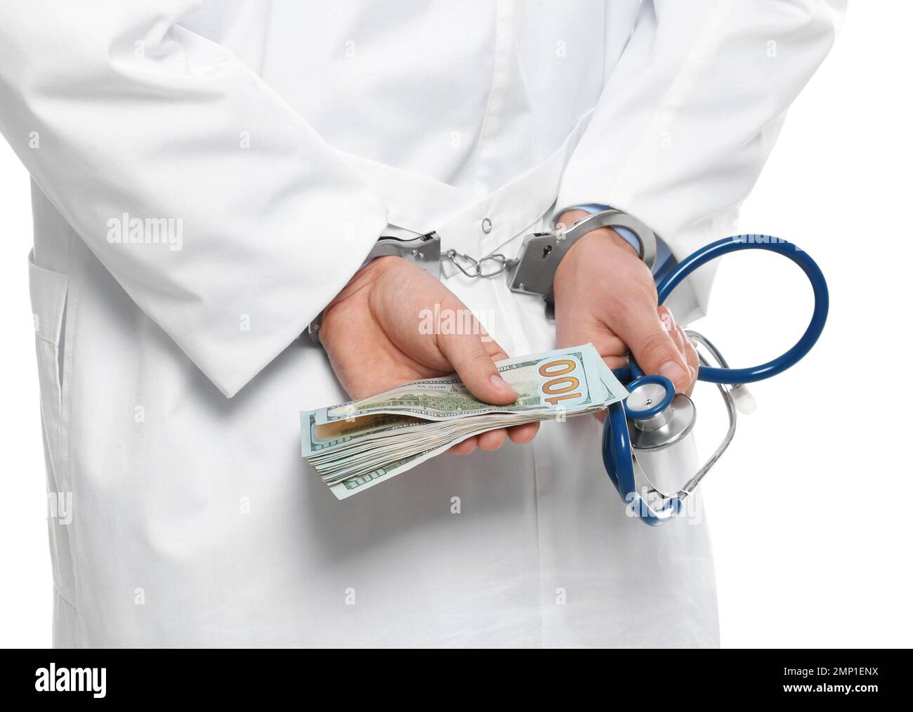 Doctor in handcuffs with bribe and stethoscope on white background ...
