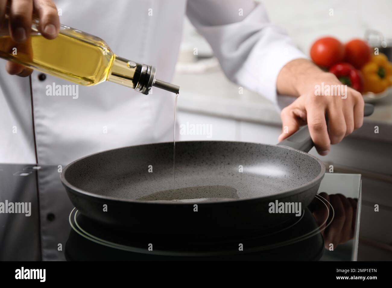Man pouring cooking oil from bottle into frying pan, closeup Stock ...