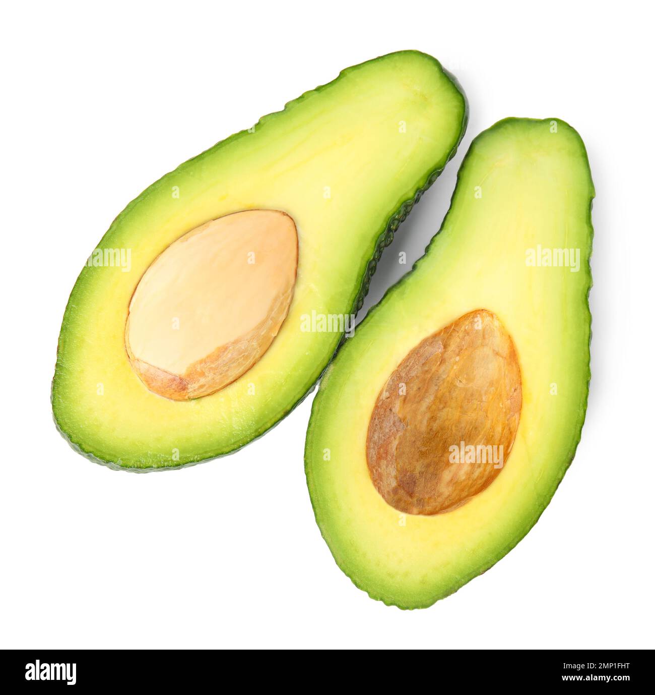 Cut tasty ripe avocados on white background, top view. Tropical fruit ...